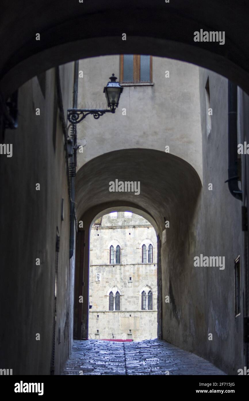 ancient arch of the stone gate in the medieval walls of the historic ...