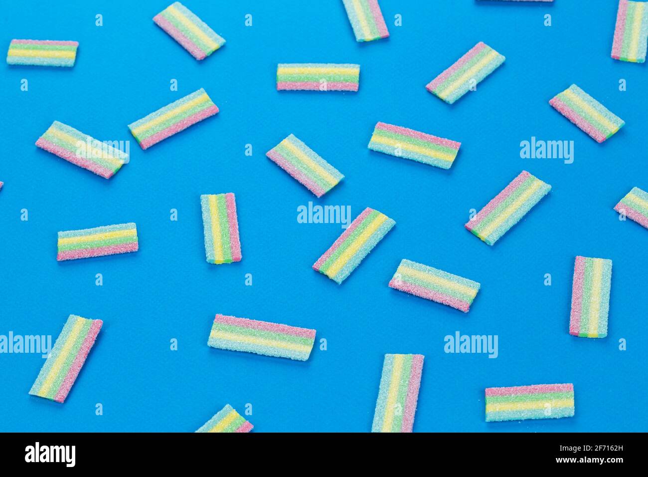 Colorful gummy candy pattern on an blue background. Soft gums look from ...