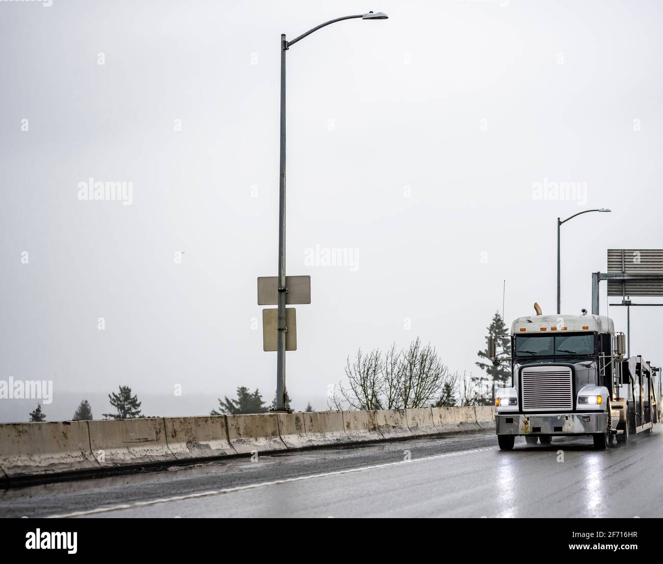 Black Big rig industrial car hauler semi truck with empty double deck ...