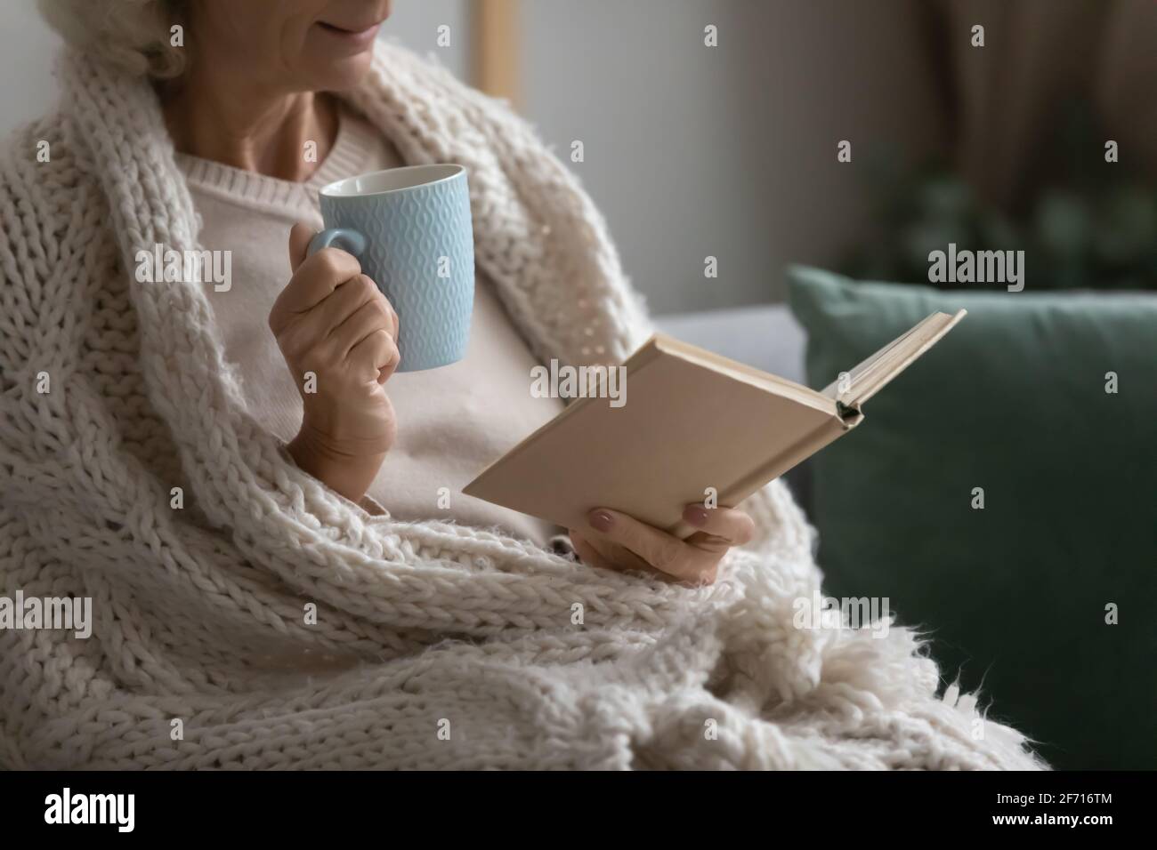 Old retired 70s lady reading book at home Stock Photo - Alamy