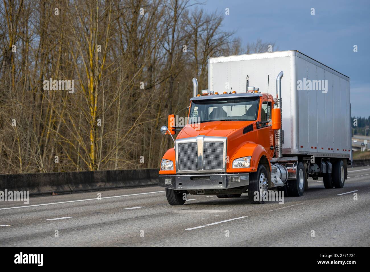 Commercial big rig orange day cab semi truck for local freight ...