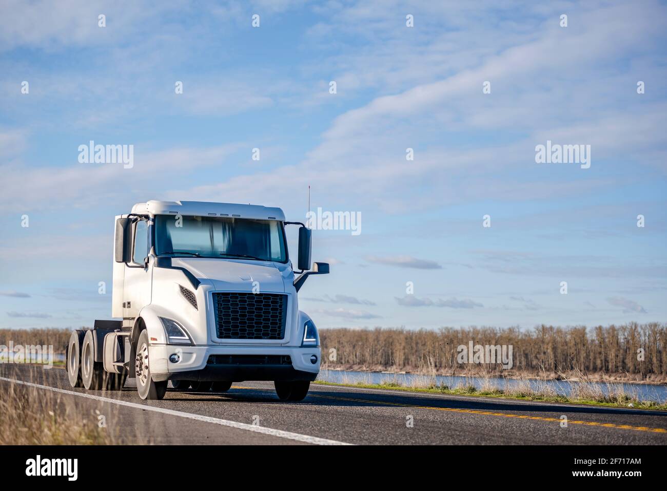 Powerful Big rig white day cab semi truck tractor without semi trailer ...