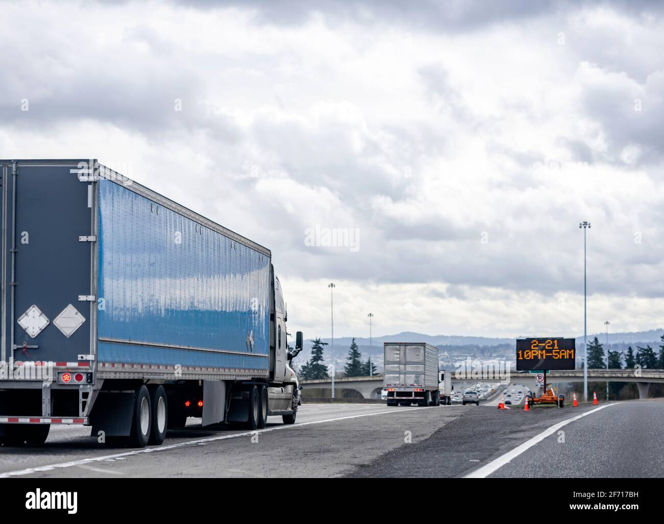 Convoy of big rigs industrial semi trucks transporting cargo in dry van ...
