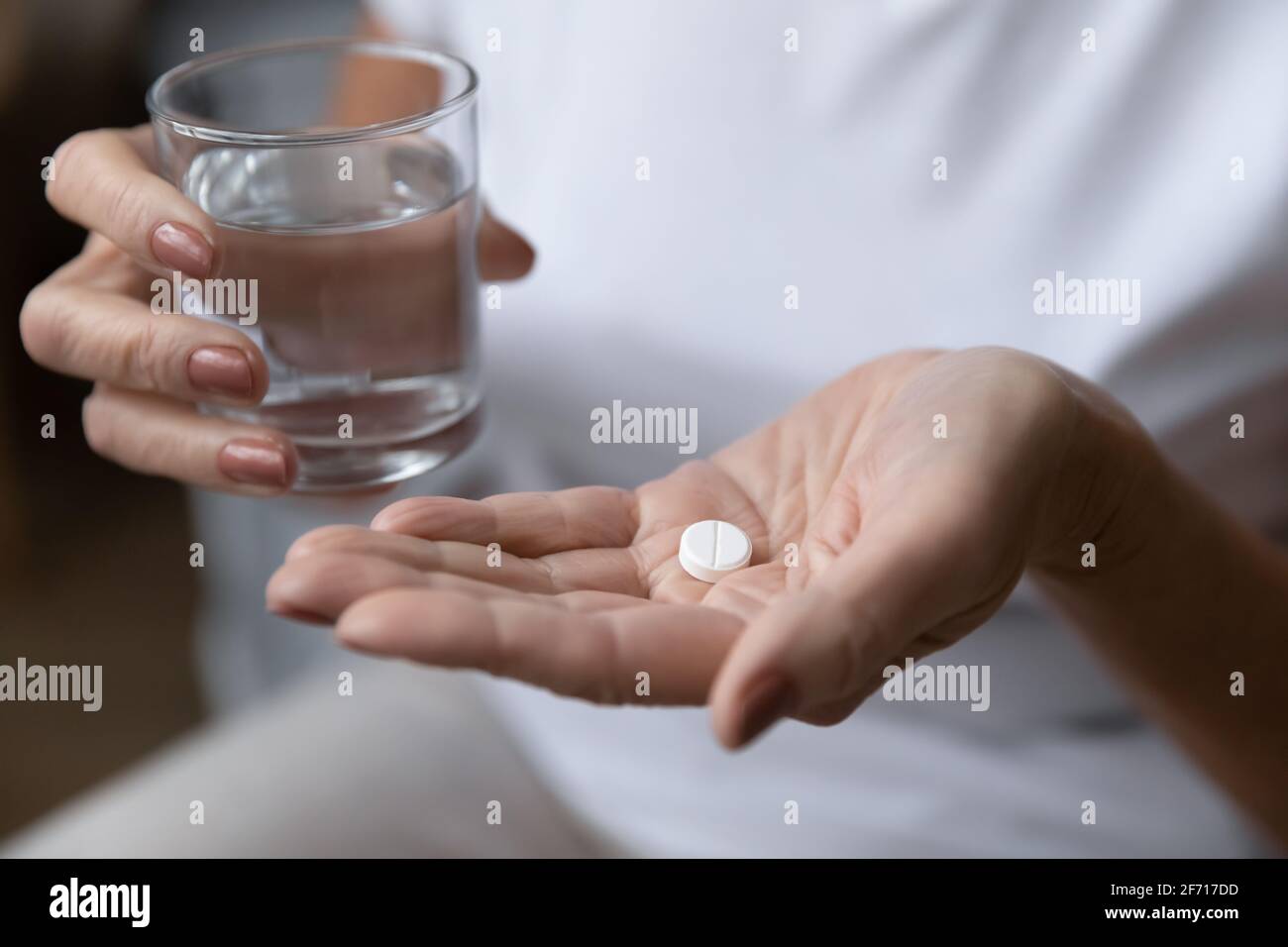 Person taking aspirin hi-res stock photography and images - Alamy