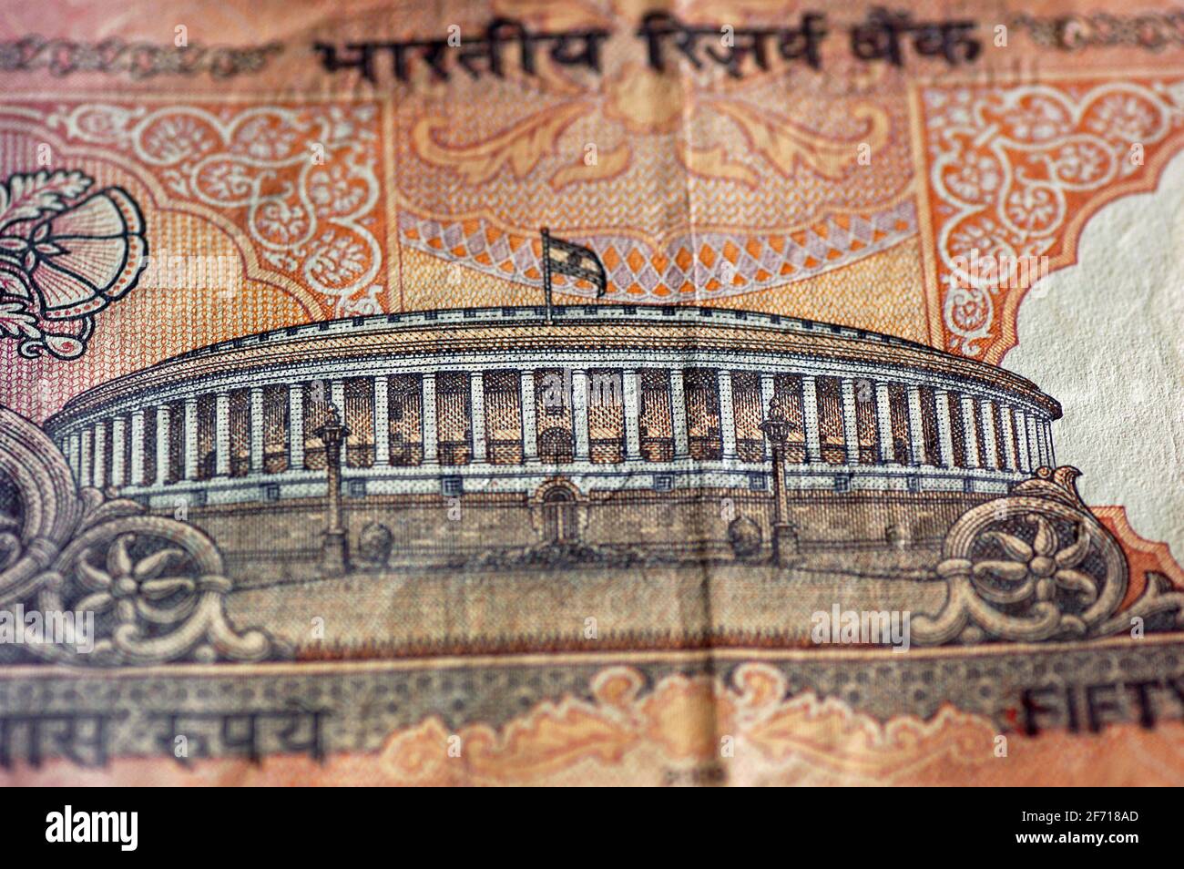 A bank of India rupee note showing the Indian parliament known as the ...