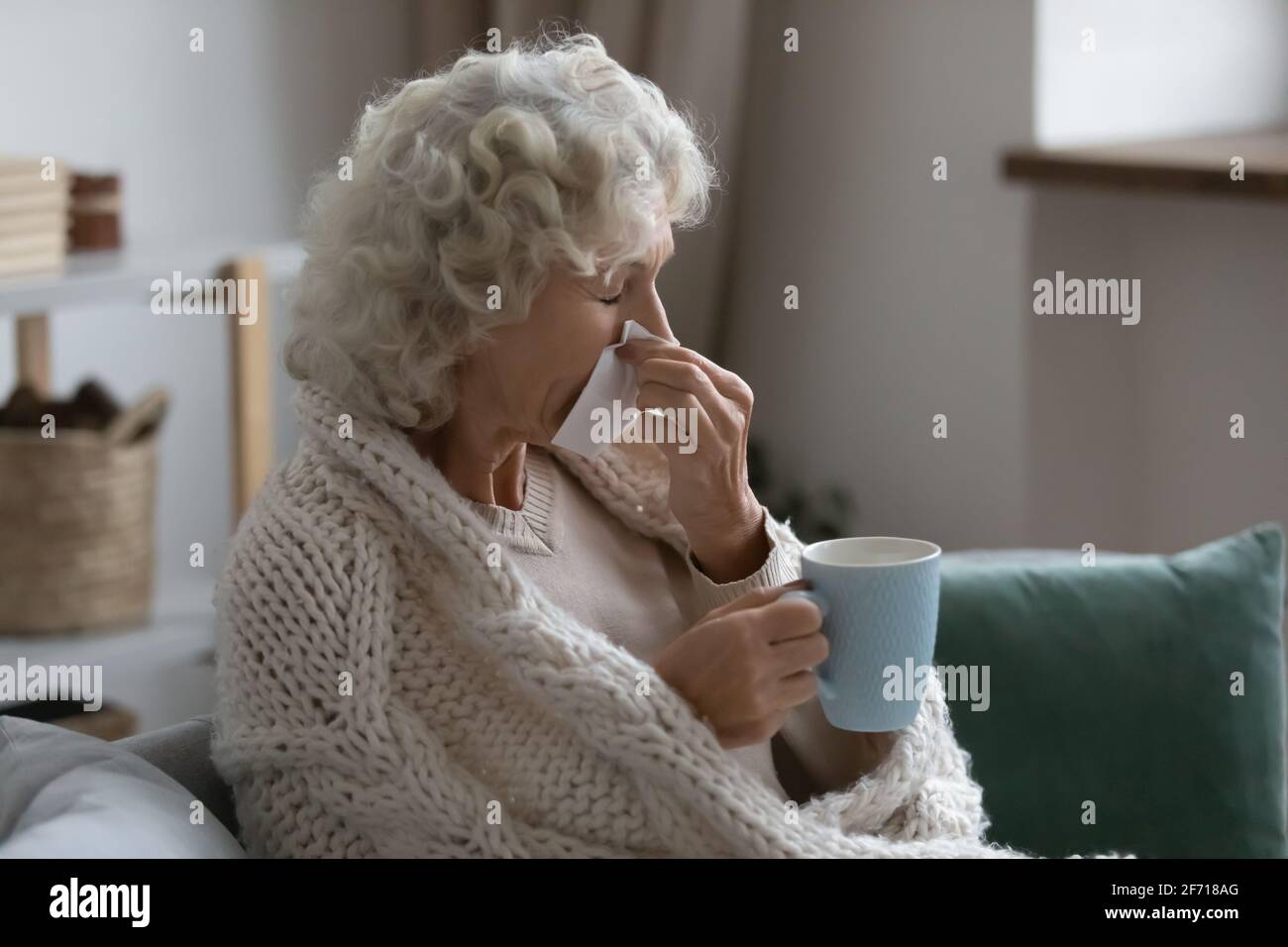 Sick elderly 60s lady suffering from cold or flu Stock Photo - Alamy