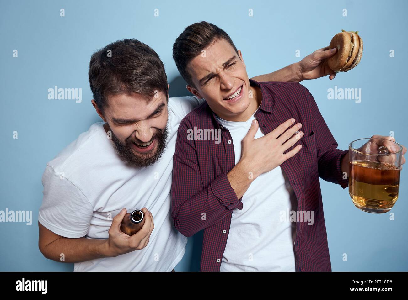 two friends with beer fun entertainment lifestyle blue background Stock ...