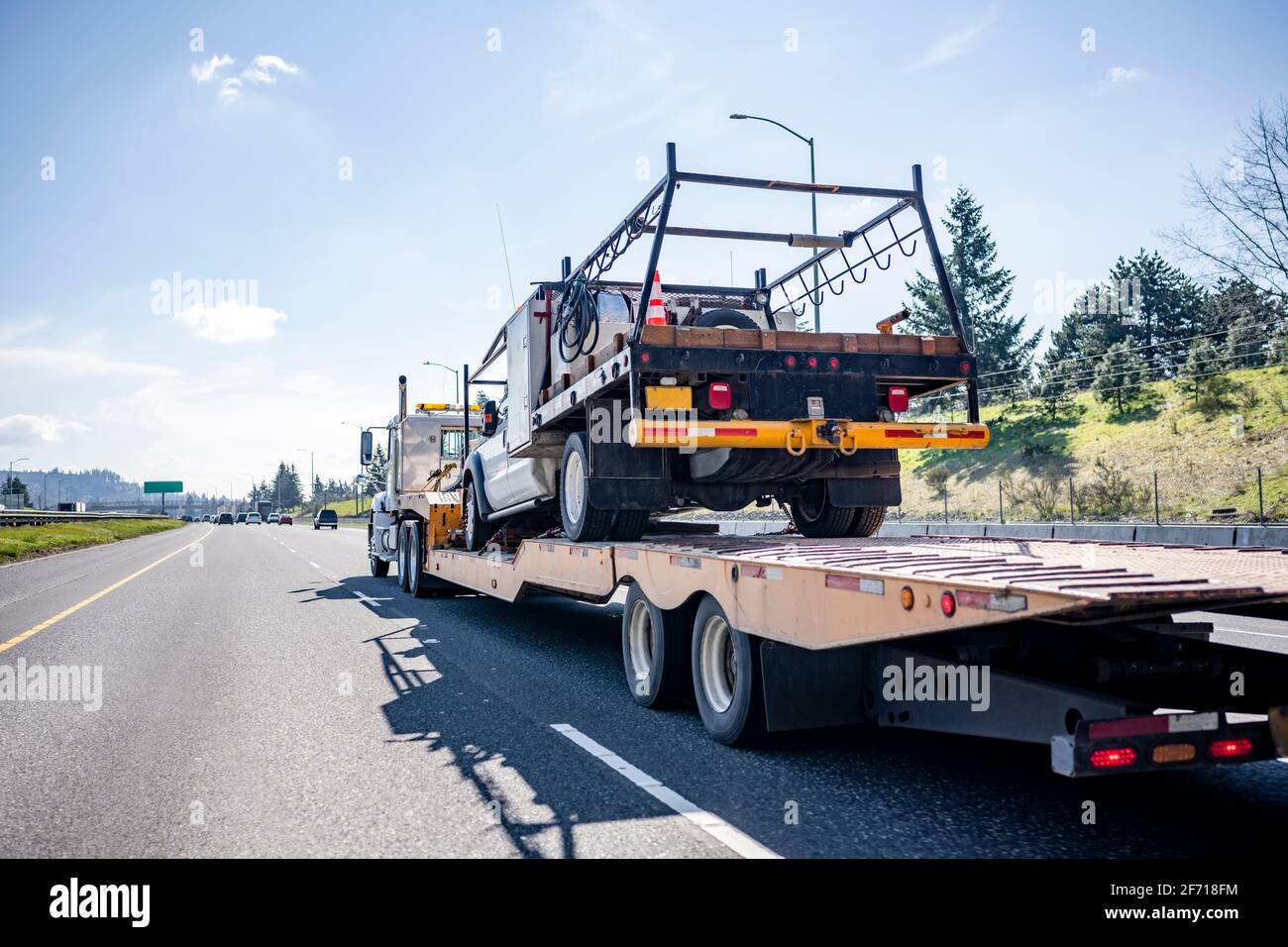 Huge white classic big rig industrial semi truck transporting another ...