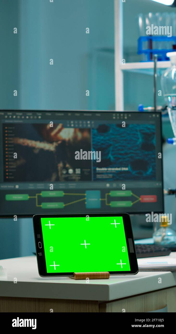 Tablet with green screen working in labooratory with mock up, chroma key display while ...