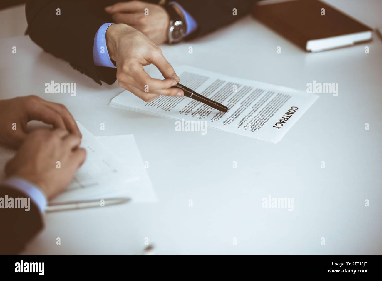 Business people, discussing contract, working together at meeting ...