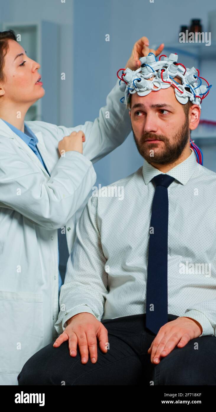 Patient with brain scan discussing with researcher neurological doctor ...