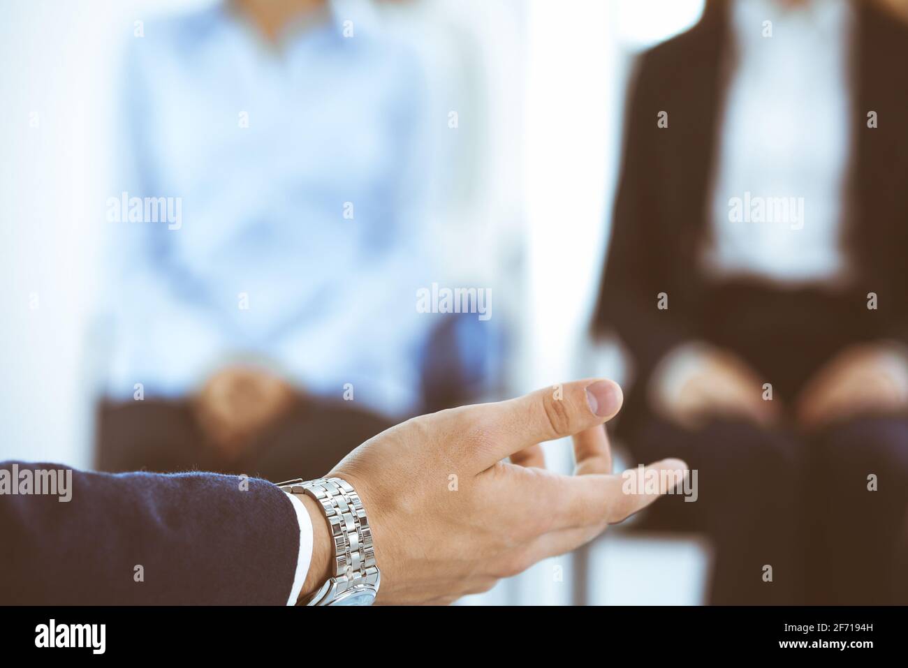 Businessman making presentation to group of people in office. Speaker ...