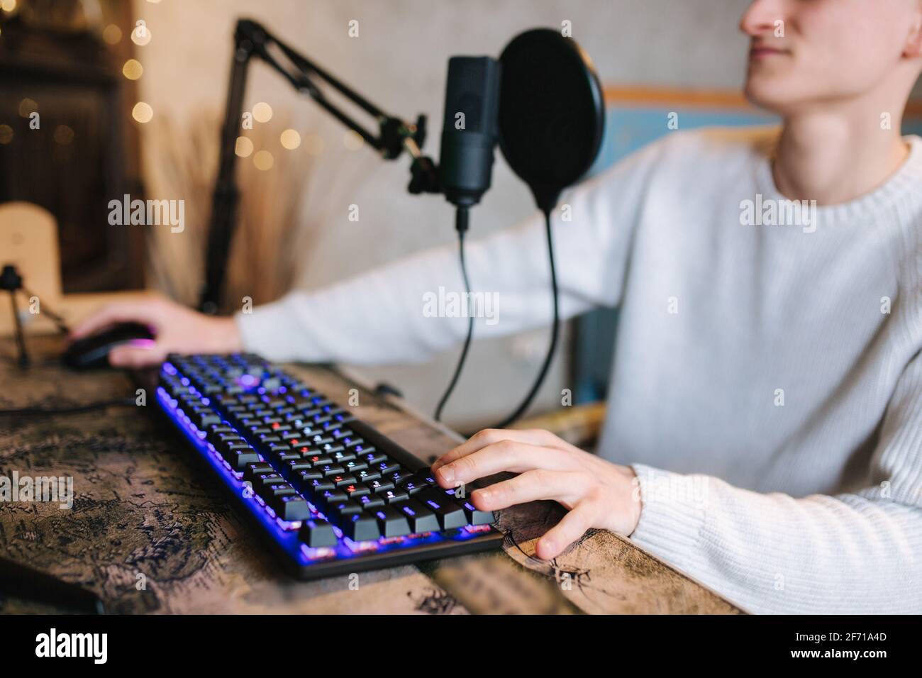 Young man makes a podcast audio recording at home. Man using pc and two ...