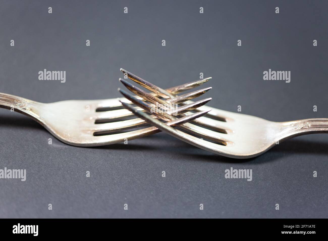 two forks on a gray background Stock Photo - Alamy