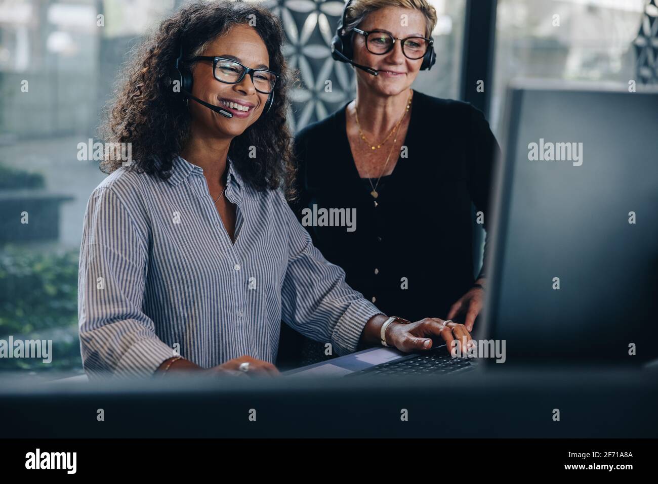 Colleagues looking computer screen in hi-res stock photography and ...