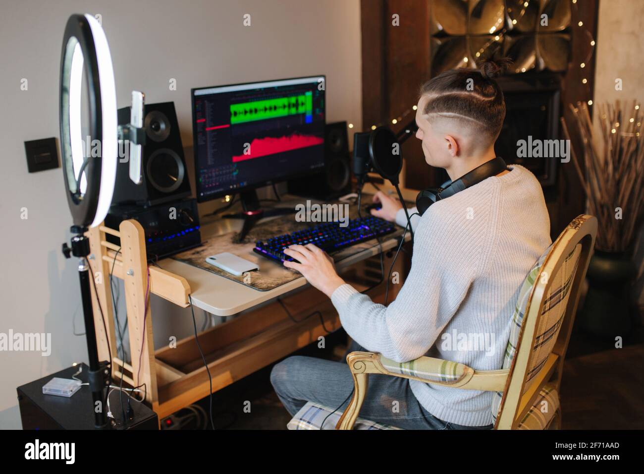 Man recording video on smartphone during the work at home on computer ...