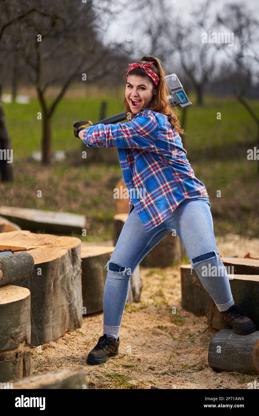 Strong woman lumberjack with her ax, splitting beech logs Stock Photo ...