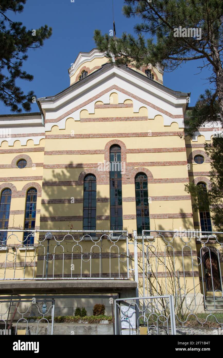 Beautiful Christian church, yellow painted building façade, blue sky ...