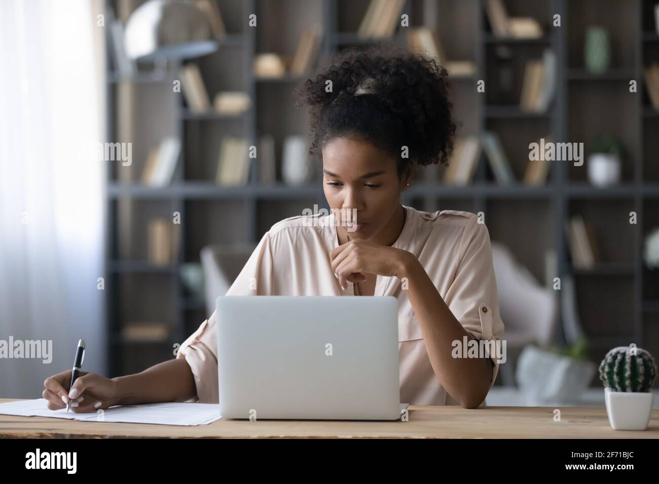 African American woman use computer working online Stock Photo - Alamy