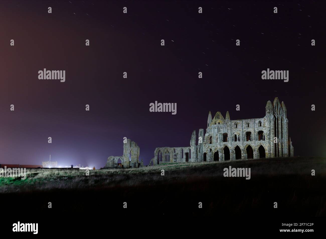 Whitby Abbey at night, illuminated by torch light Stock Photo - Alamy