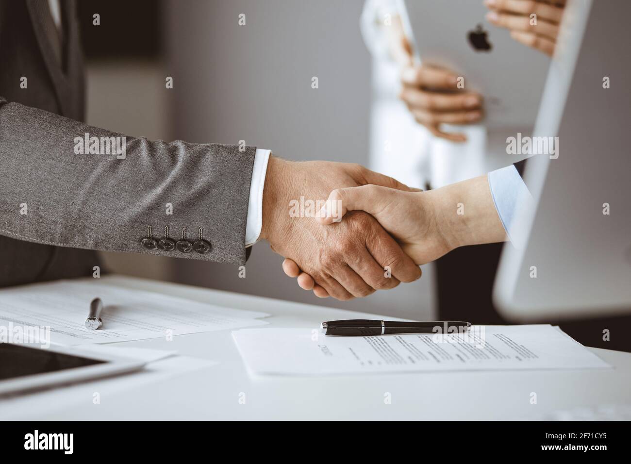 Business people shaking hands finishing contract signing, close-up ...