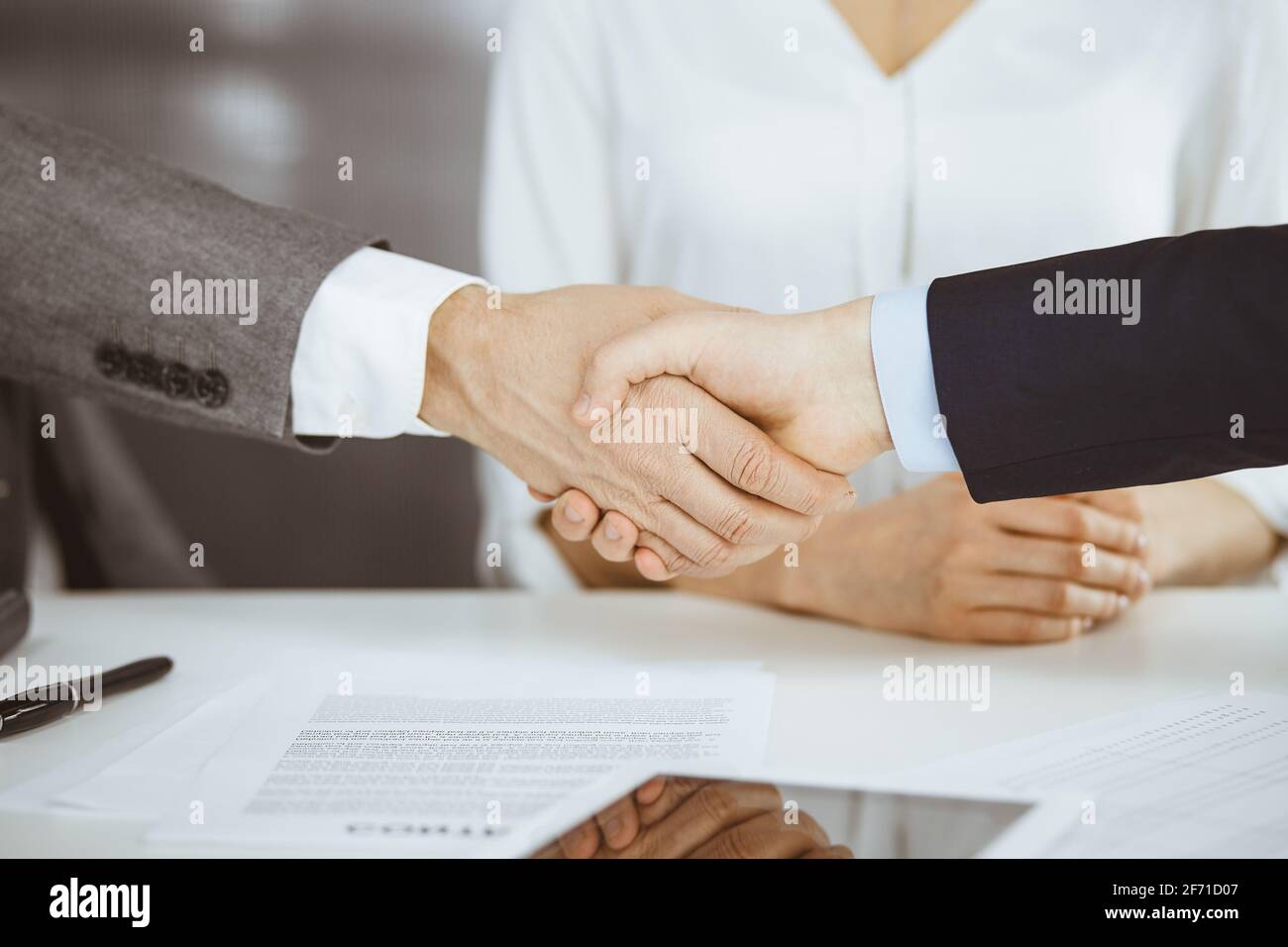 Business people shaking hands finishing contract signing, close-up ...
