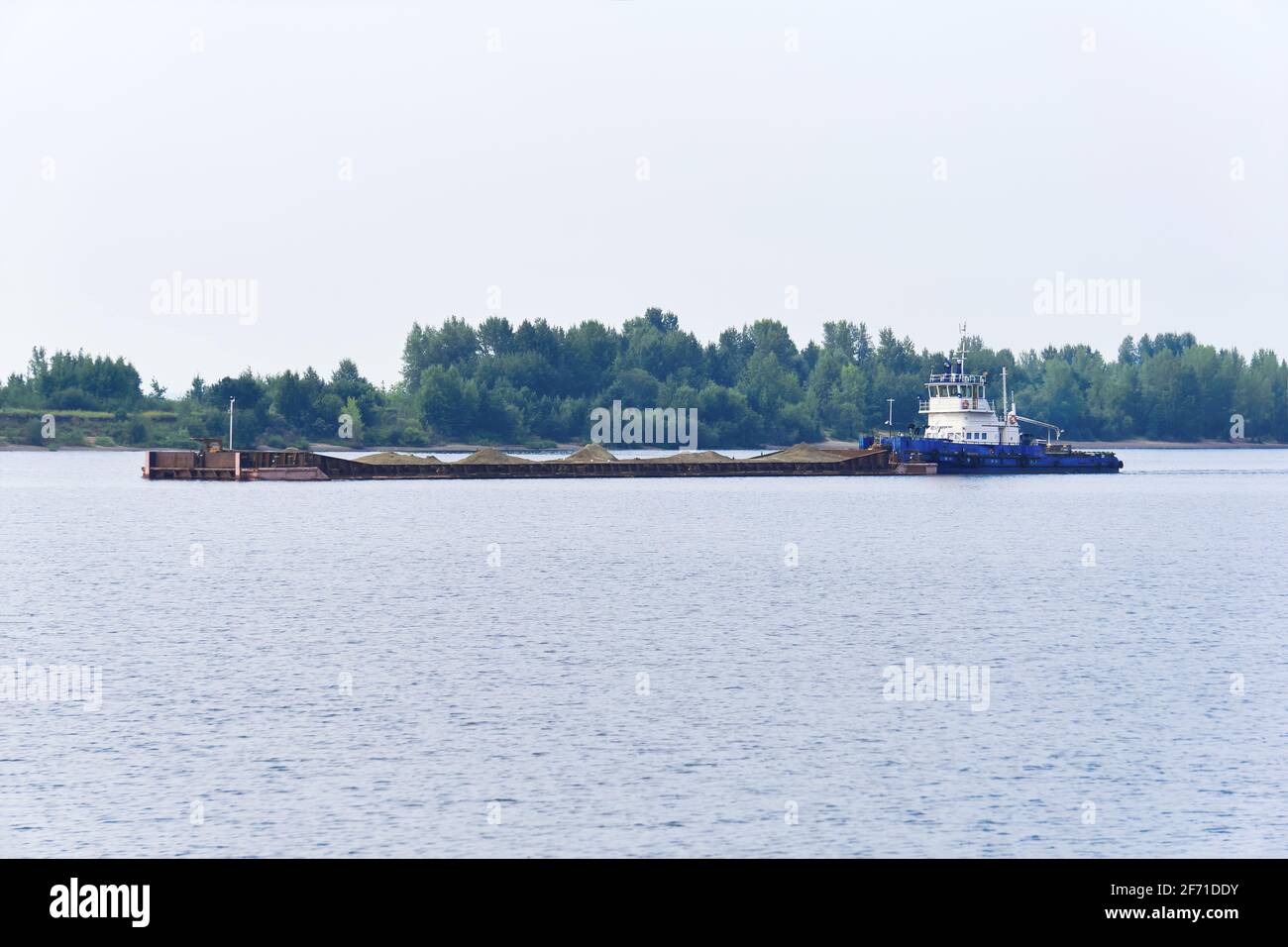 towboat pushes dry bulk cargo barge with sand on the river Stock Photo ...