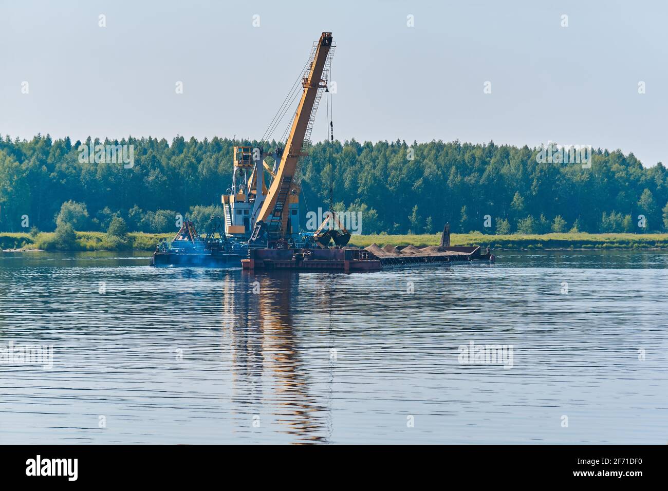 dredging boat is working to deepen the fairway on the river Stock Photo ...