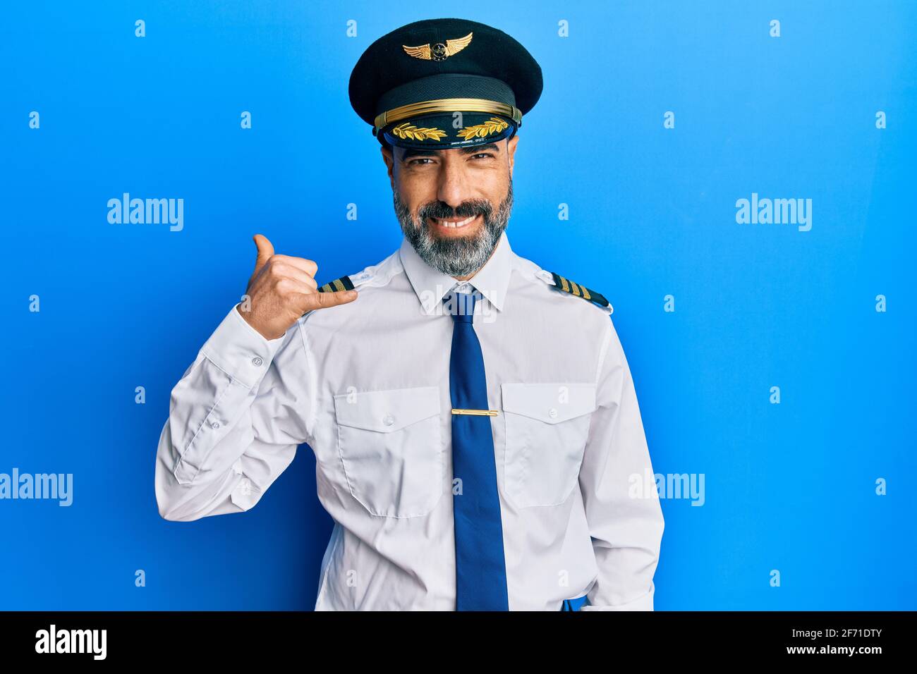 Middle age man with beard and grey hair wearing airplane pilot uniform ...