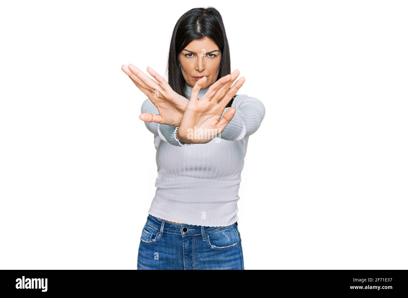 Beautiful brunette woman wearing casual clothes rejection expression ...