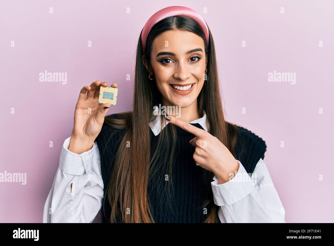 Beautiful brunette young woman holding cpu processor computer smiling ...