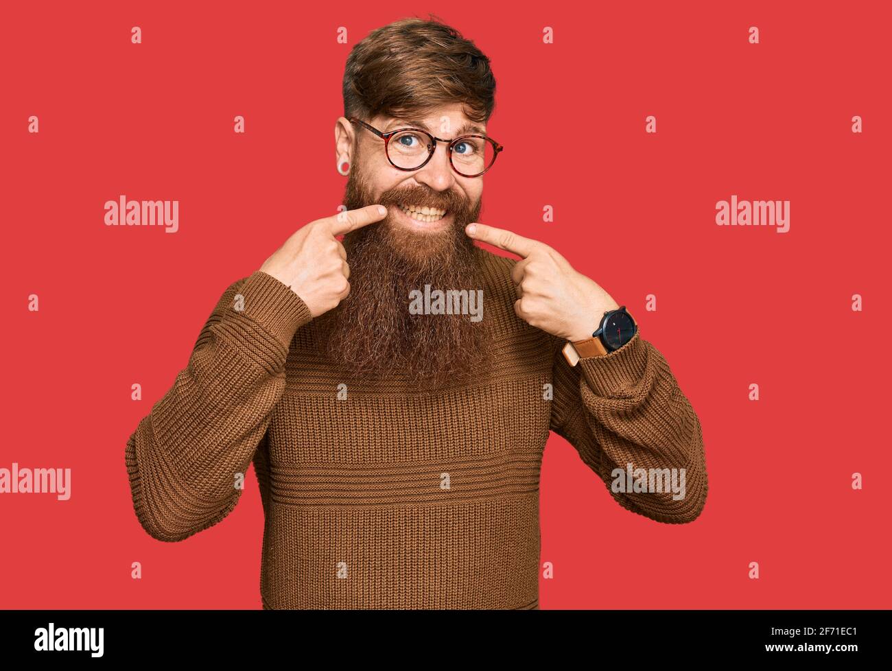 Young irish redhead man wearing casual clothes and glasses smiling ...