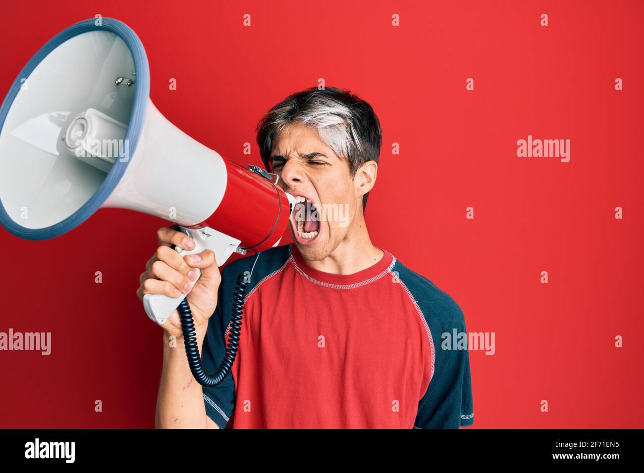 Young man shouting with anger and energy through megaphone Stock Photo ...