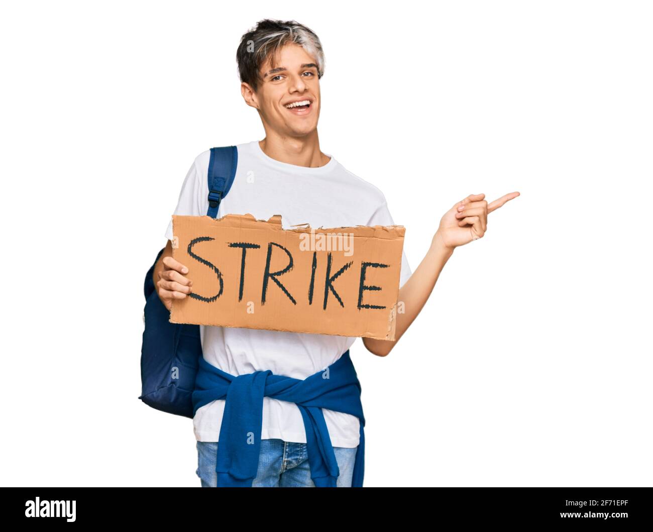 Young hispanic man holding strike banner cardboard smiling happy ...