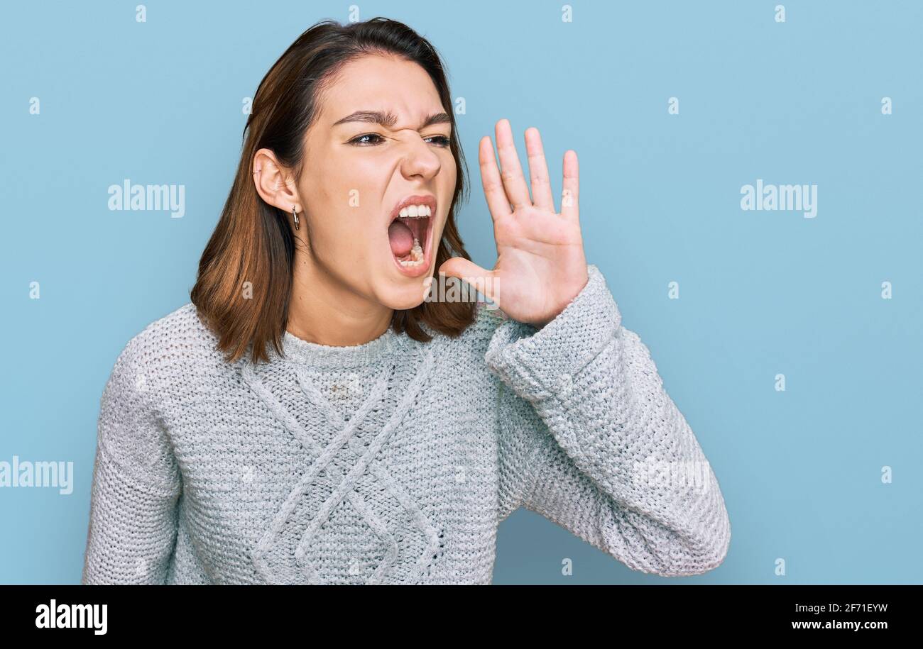 Young caucasian girl wearing casual clothes shouting and screaming loud ...