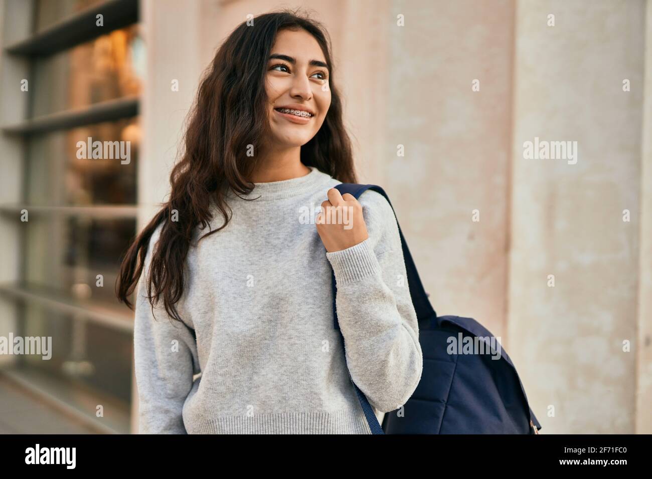 Young middle east student girl smiling happy standing at the city Stock ...