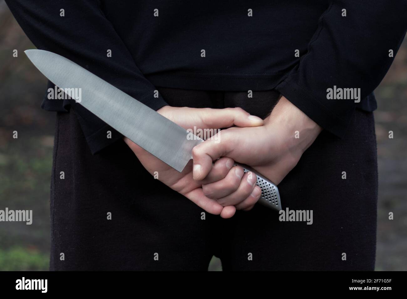Hiding knife hi-res stock photography and images - Alamy