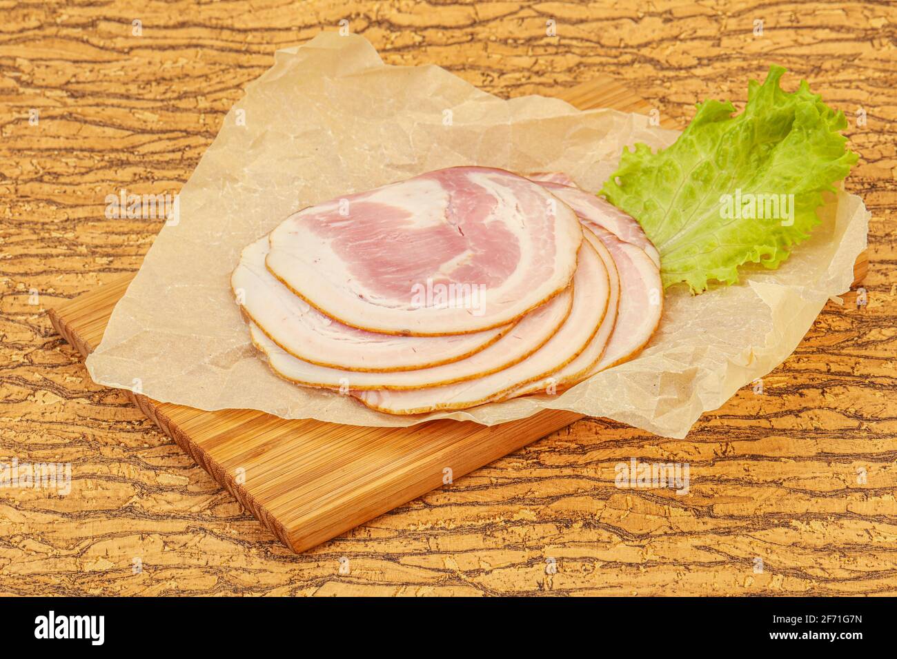 Sliced Italian Pancetta sausage over board Stock Photo - Alamy