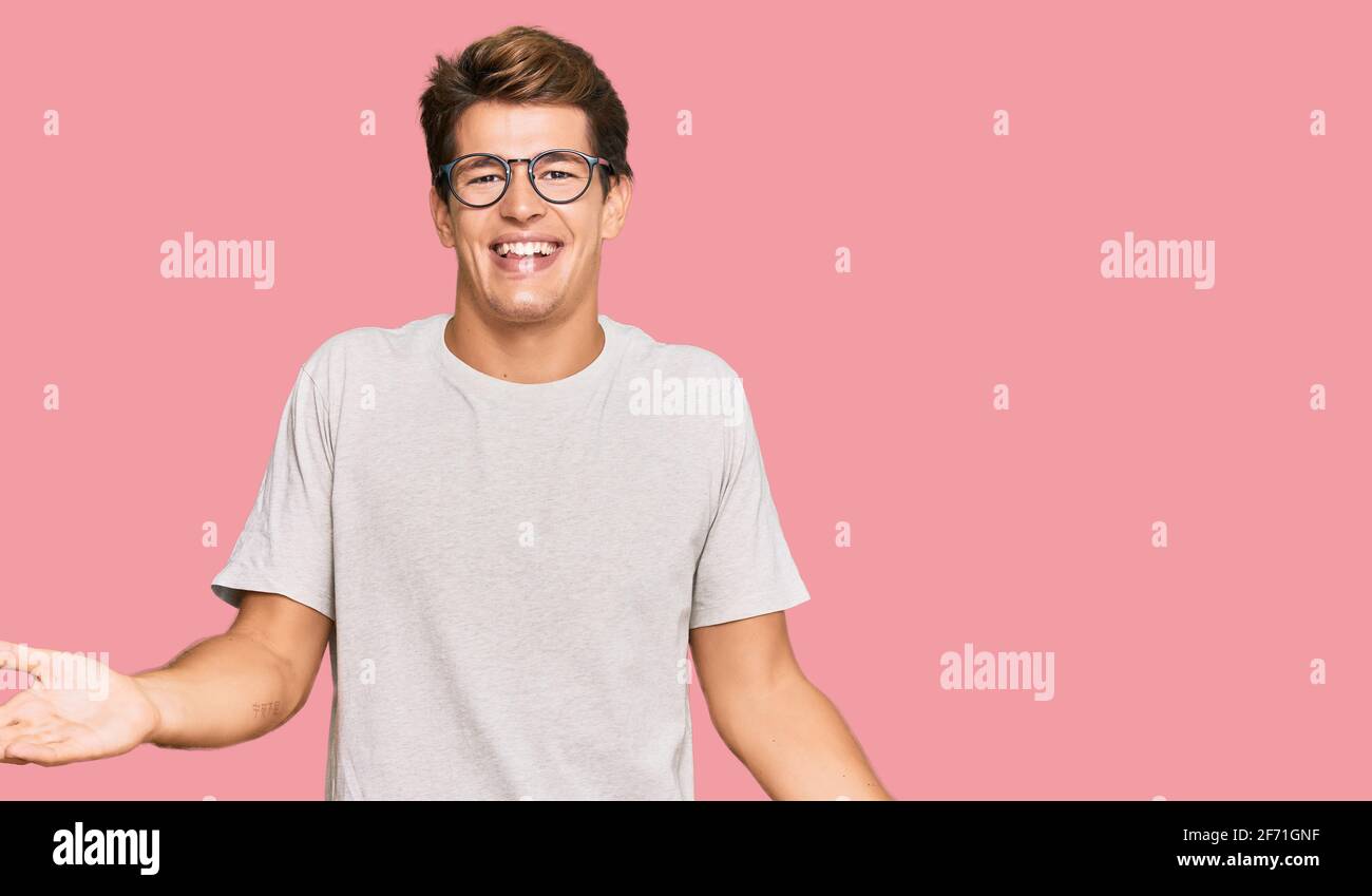 Handsome caucasian man wearing casual clothes and glasses smiling ...