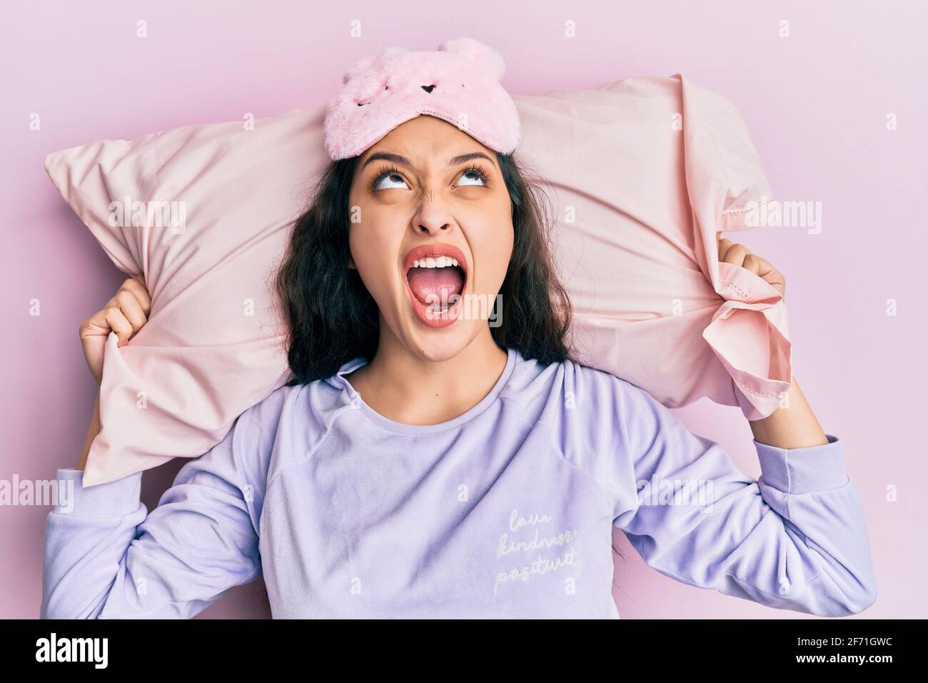 Beautiful middle eastern woman wearing sleep mask and pajama sleeping ...