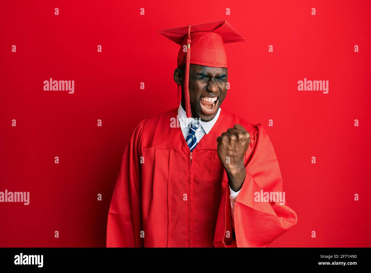 Young african american man wearing graduation cap and ceremony robe ...