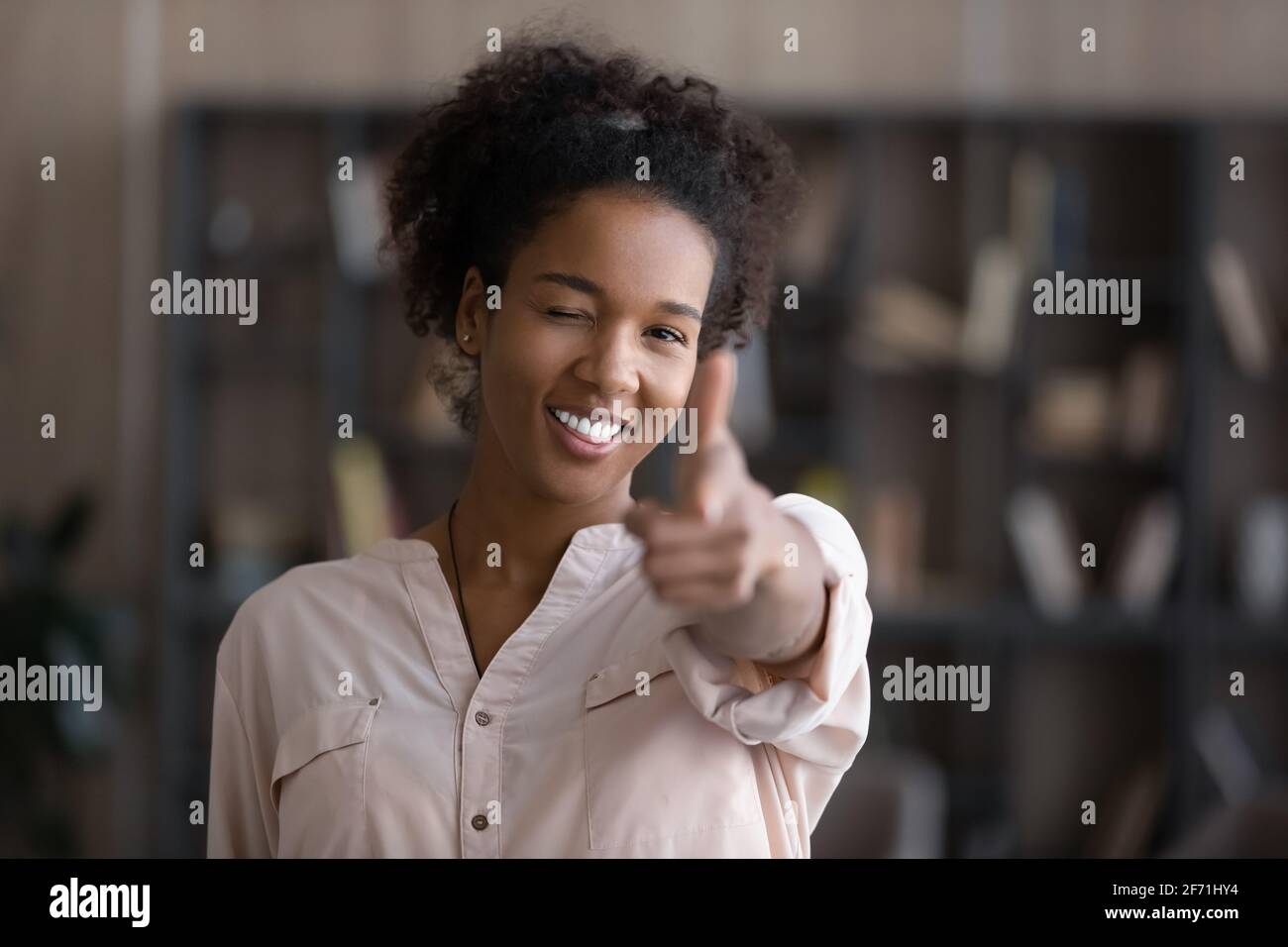 Portrait of smiling biracial woman point at screen Stock Photo - Alamy