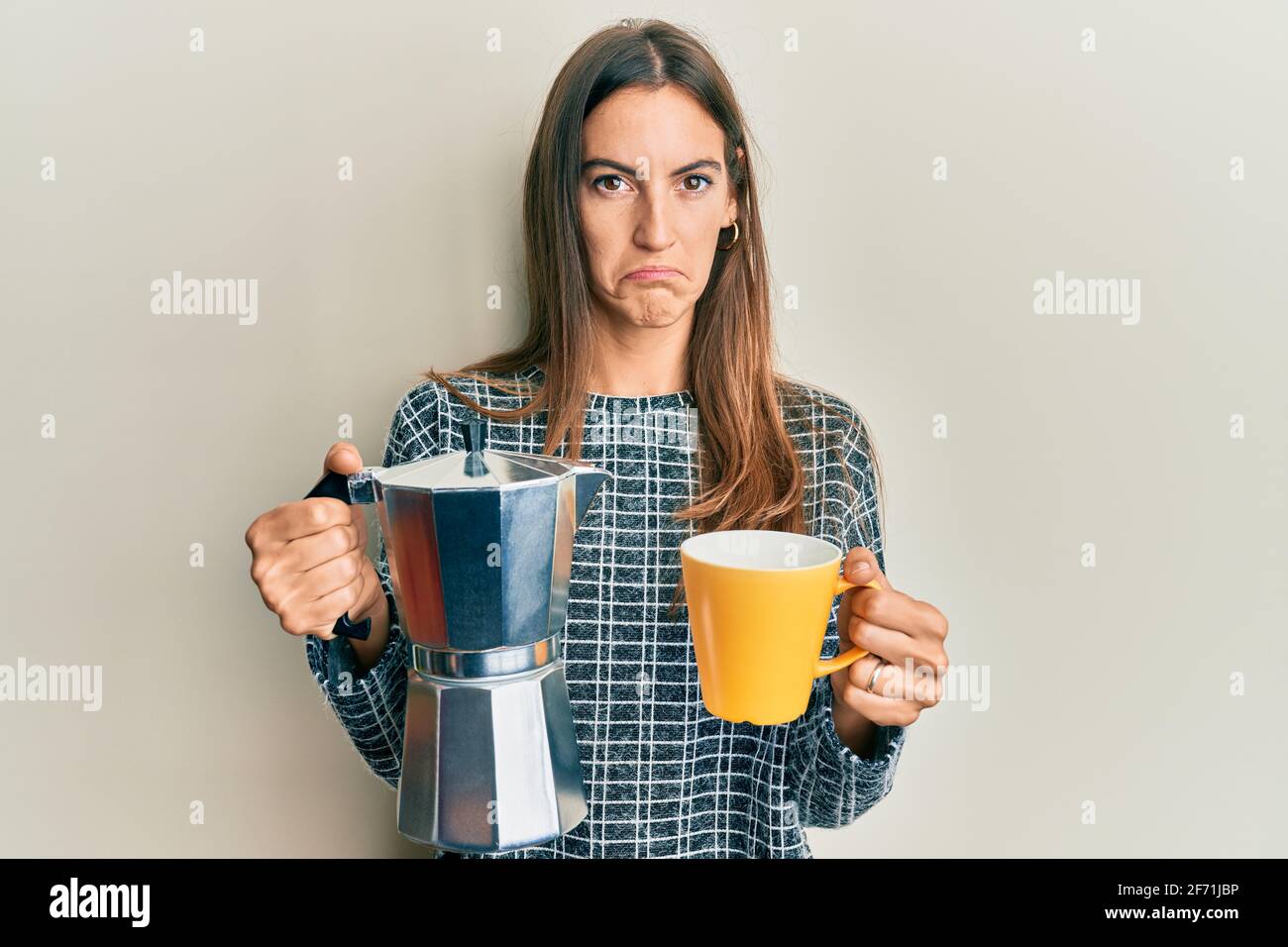 Young beautiful woman drinking italian coffee depressed and worry for ...