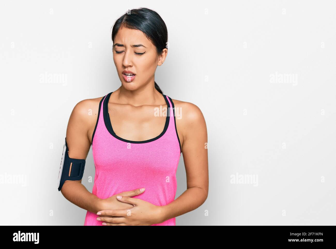 Beautiful asian young sport woman wearing sportswear and arm band with ...