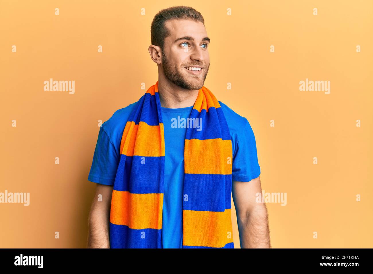 Young caucasian man football hooligan cheering game looking to side ...