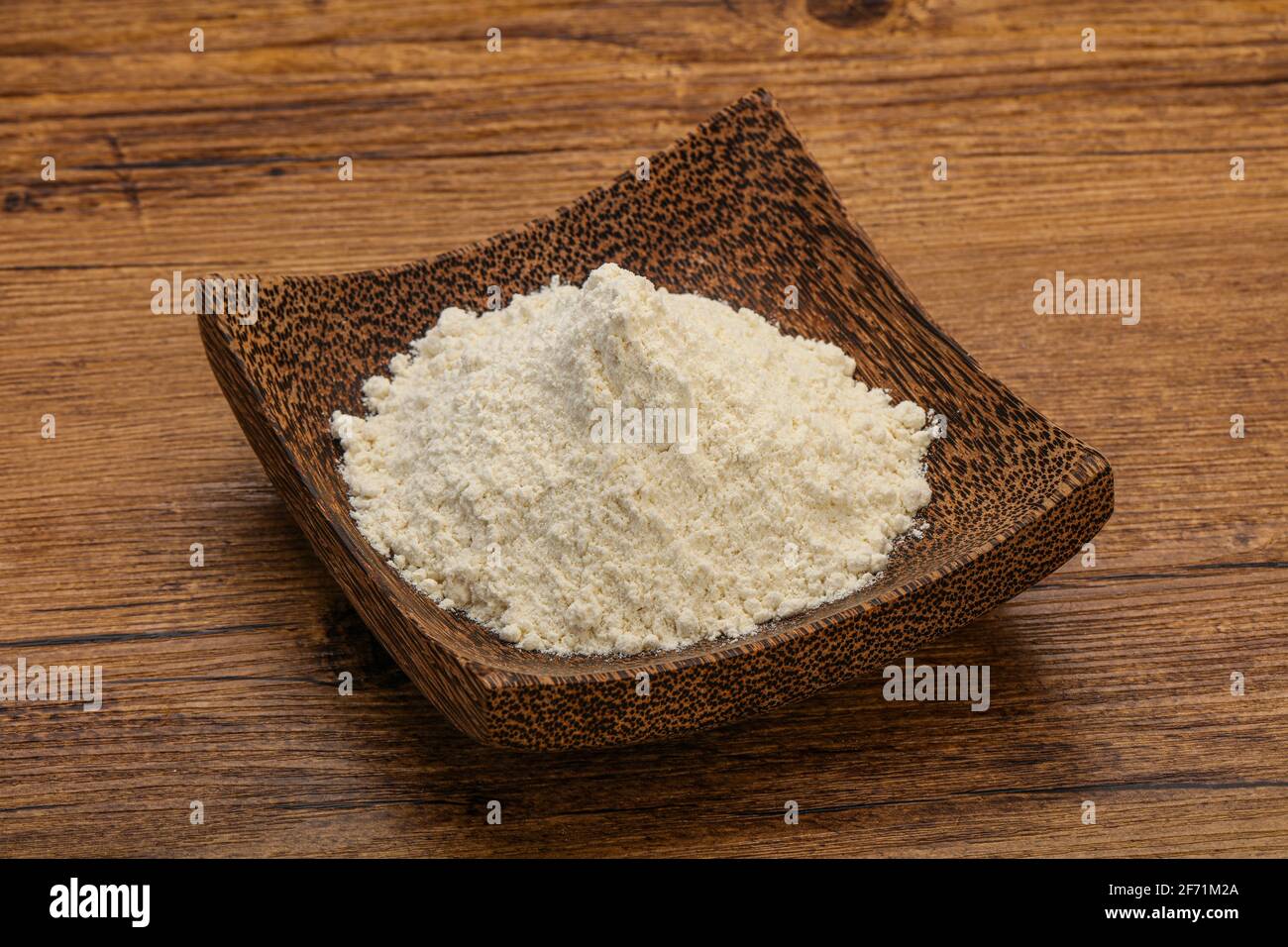 Wheat flour heap in the bowl for cooking Stock Photo - Alamy