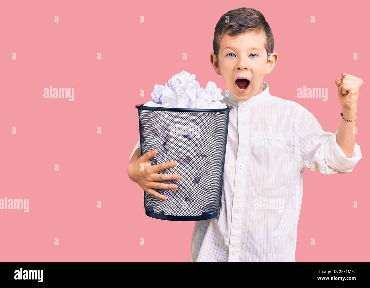 Cute blond kid holding paper bin full of crumpled papers screaming ...