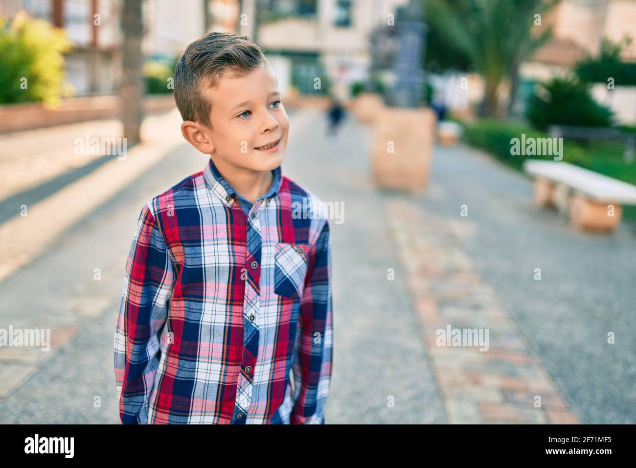 Adorable caucasian boy smiling happy standing at the city Stock Photo - Alamy