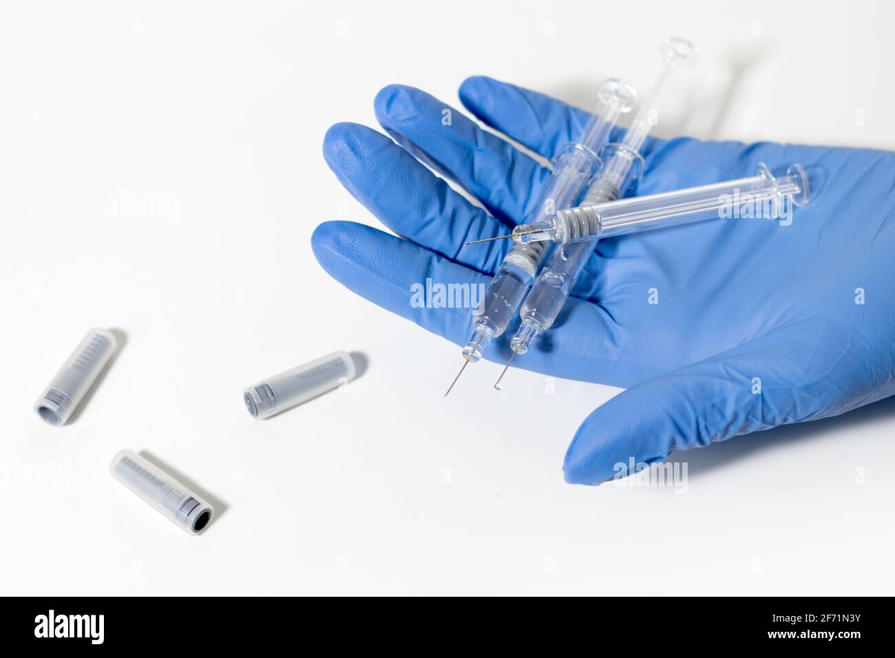 Hand holding syringe isolated on white Stock Photo - Alamy