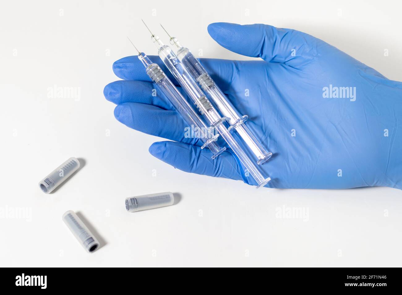 Hand holding syringe isolated on white Stock Photo - Alamy